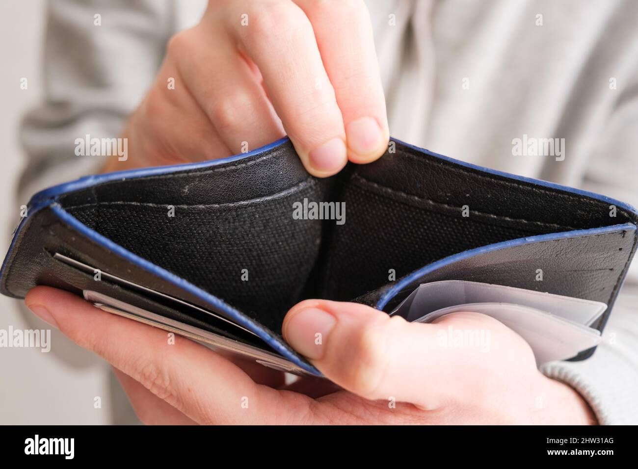 Man hand showing an open empty wallet close up. Poverty, cost control ...