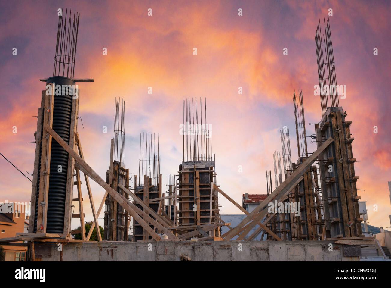 Foundation of a construction on sunset background. First step of a new ...