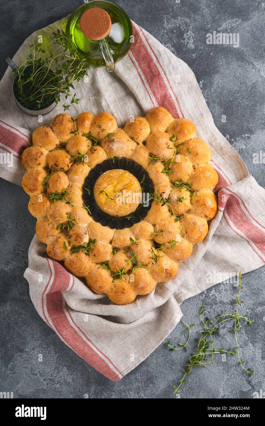 Roasted camembert cheese and homemade bread heart shaped and thyme on ...