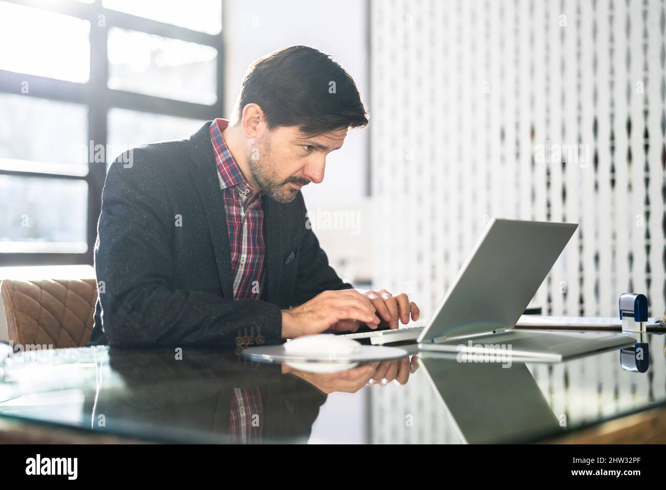 Man Sitting In Bad Posture Working On Computer In Office Stock Photo ...