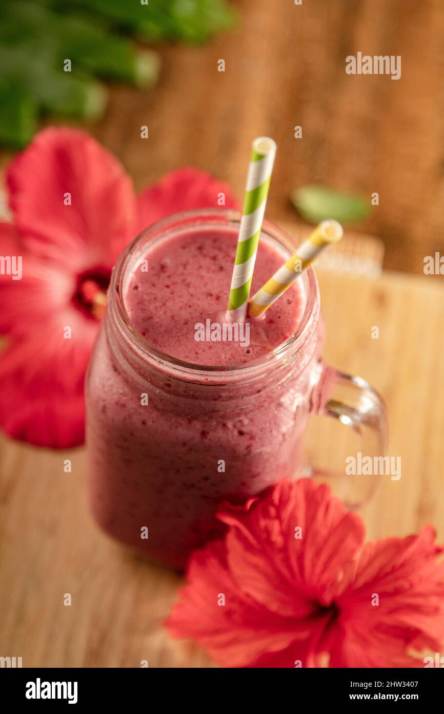 Closeup of a strawberry smoothie with Hibiscus flowers Stock Photo - Alamy