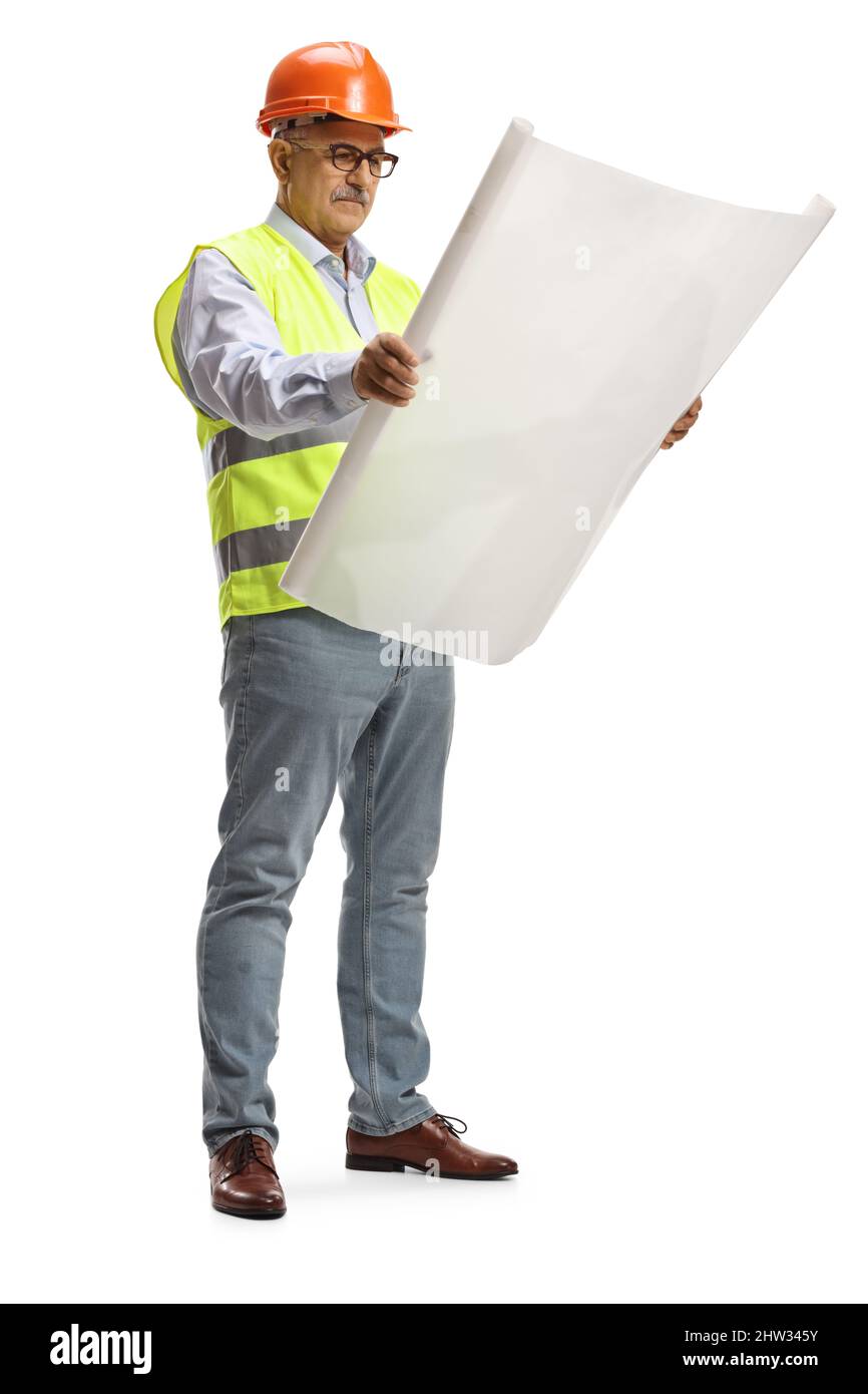 Full length portrait of a male engineer standing and reading a ...