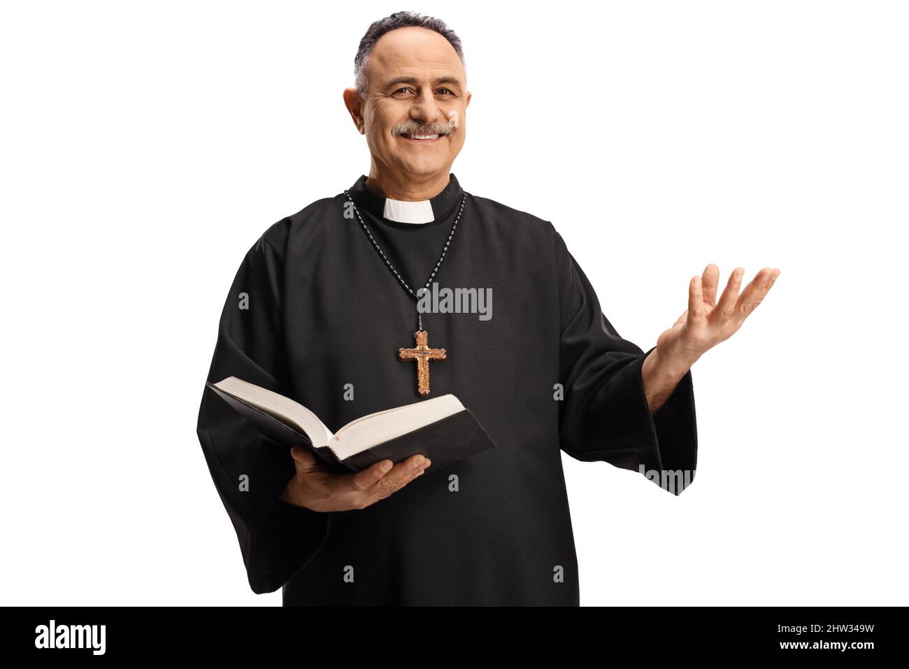 Smiling mature priest holding an open bible isolated on white ...