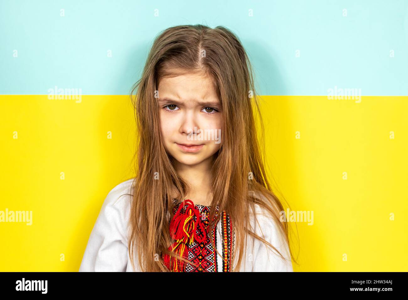A girl is crying, holding a STOP poster on the background of the ...