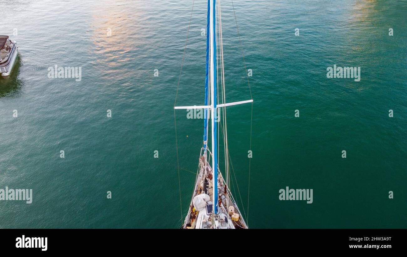High angle shot of a crossbar of the sailboat swimming at calm sunrise ...