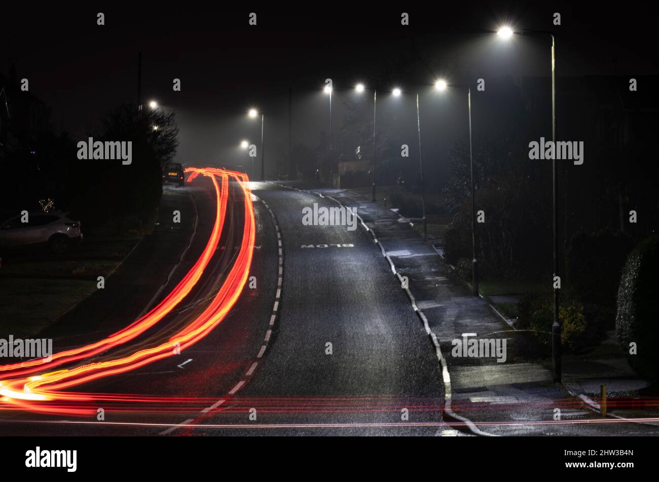 Streaks from car headlights and rear lights as they drive along a ...