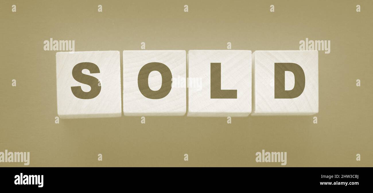 Sold Word Written In Wooden Cubes on black background. Real estate ...