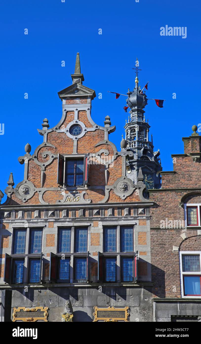 Closeup of medieval gabled house facades with church tower against blue ...