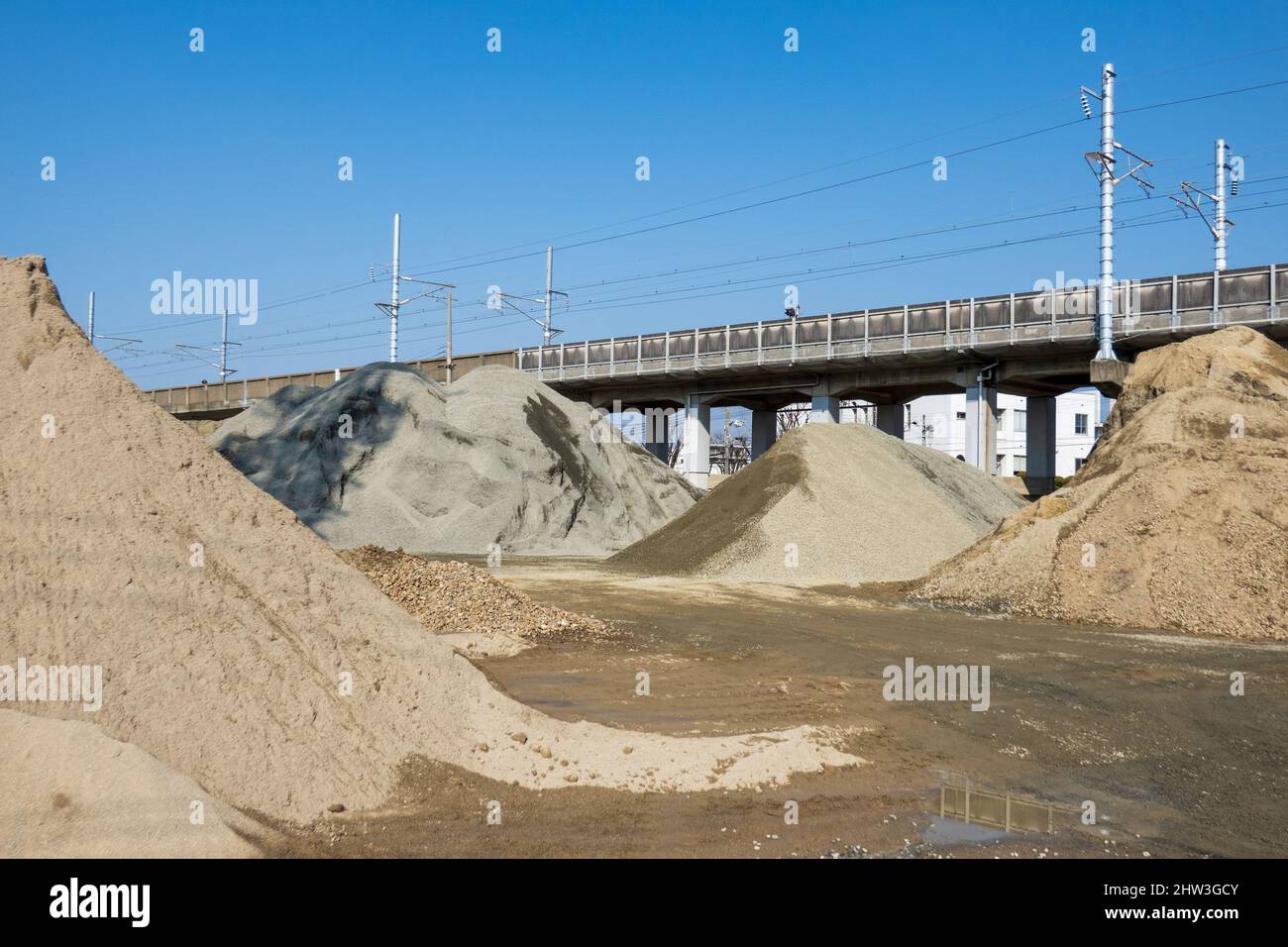 Piles of sand and rock aggregate in construction yard Stock Photo - Alamy