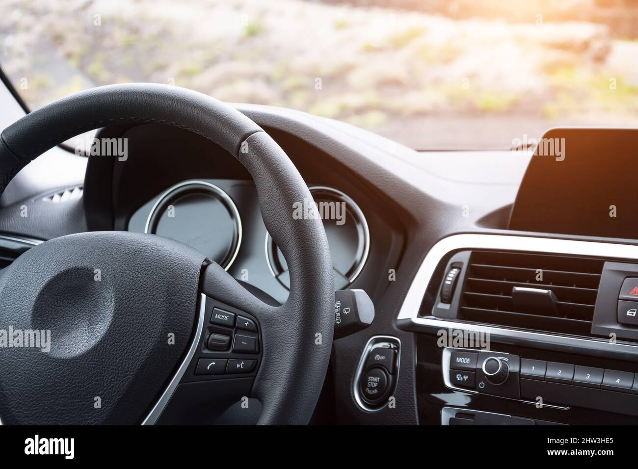 Close up view of the steering wheel and the front panel of the car ...