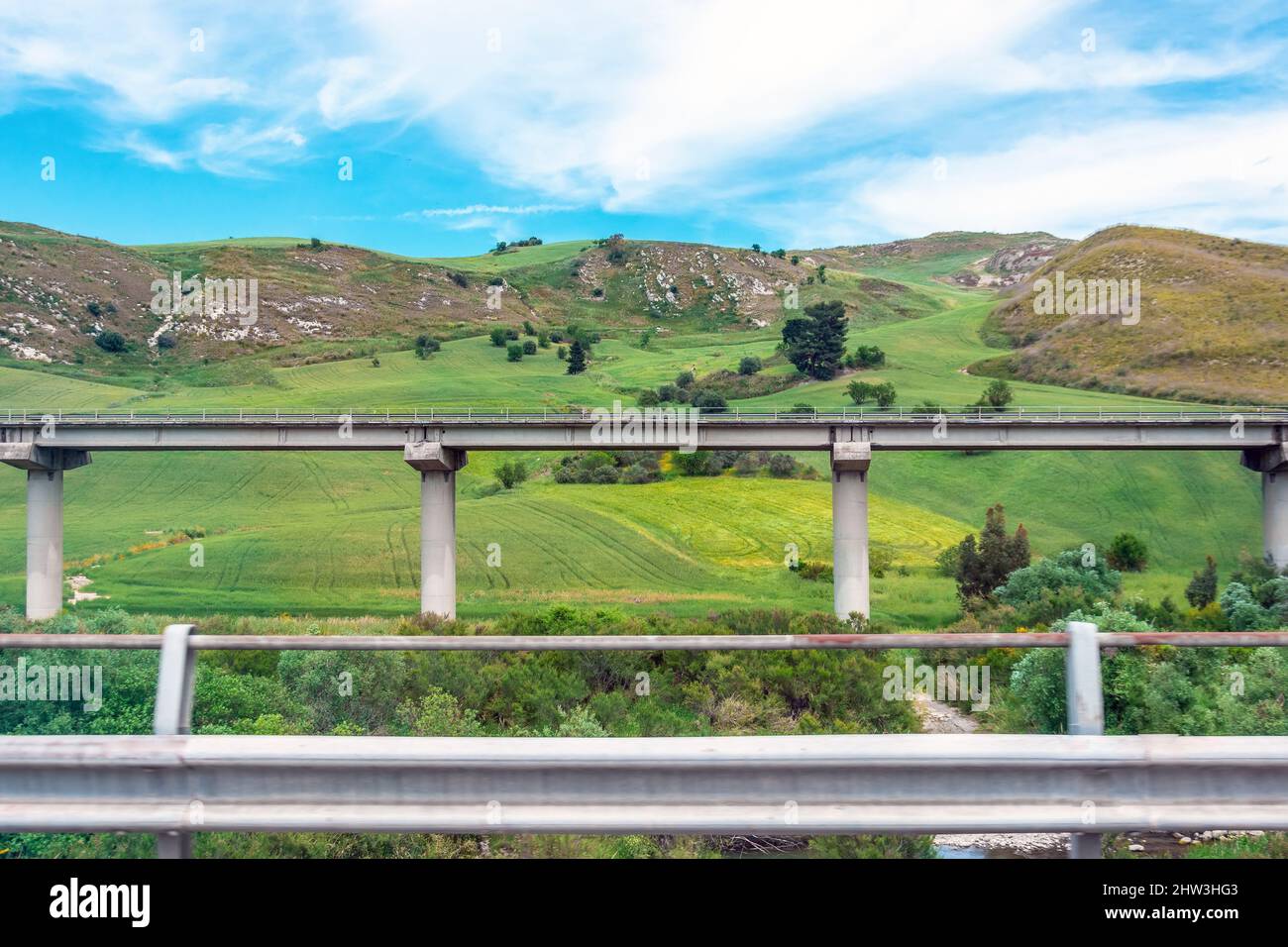 Road highway bridge, viaduct supports in the valley among the green ...