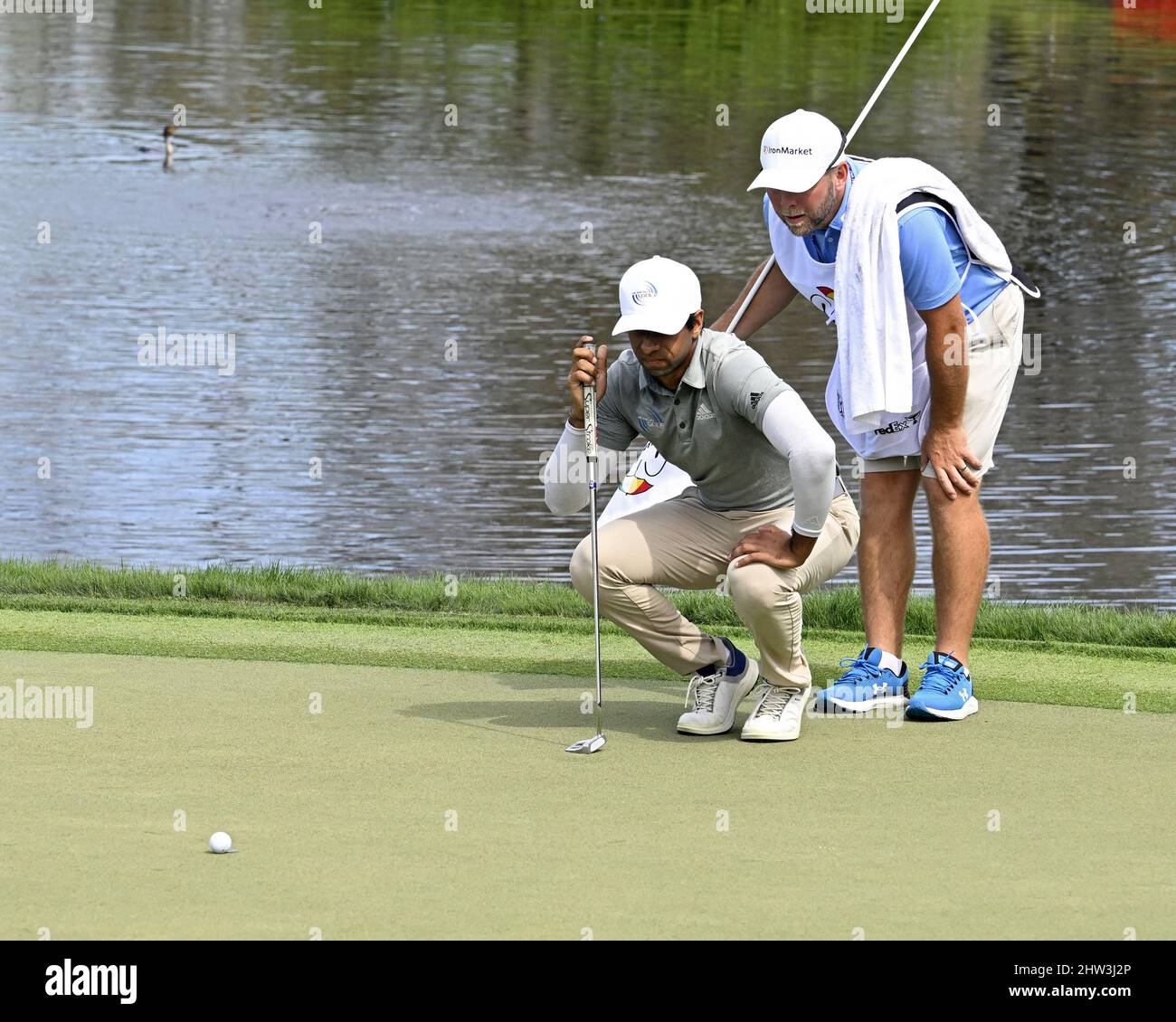 Orlando, United States. 03rd Mar, 2022. Aaron Rai (l) lines up a putt ...