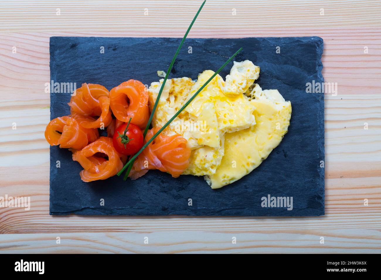 Traditional dish of Norwegian cuisine of omelet with salmon at plate ...