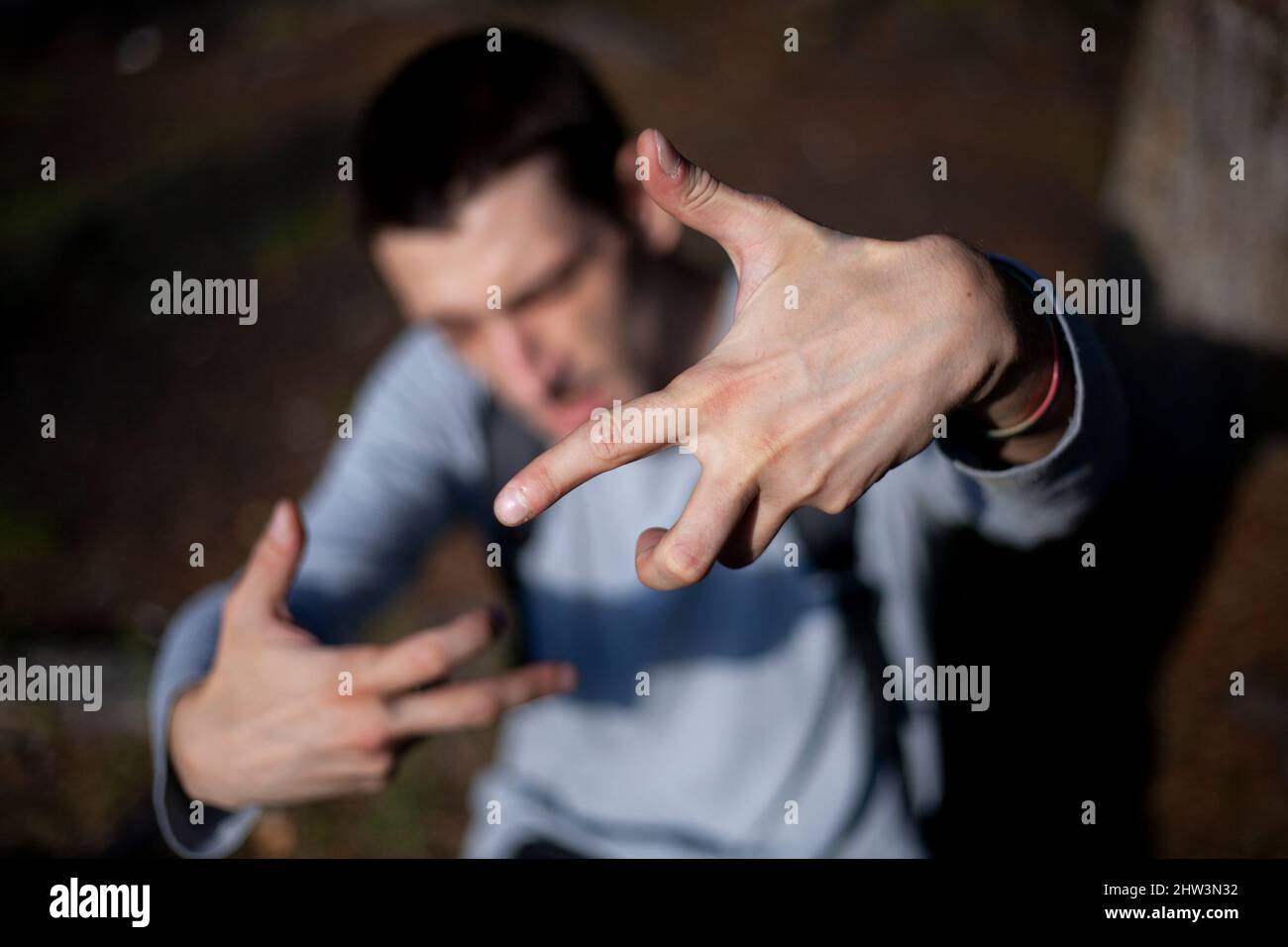 A young man shows gestures with his hands. The guy shows movements with ...