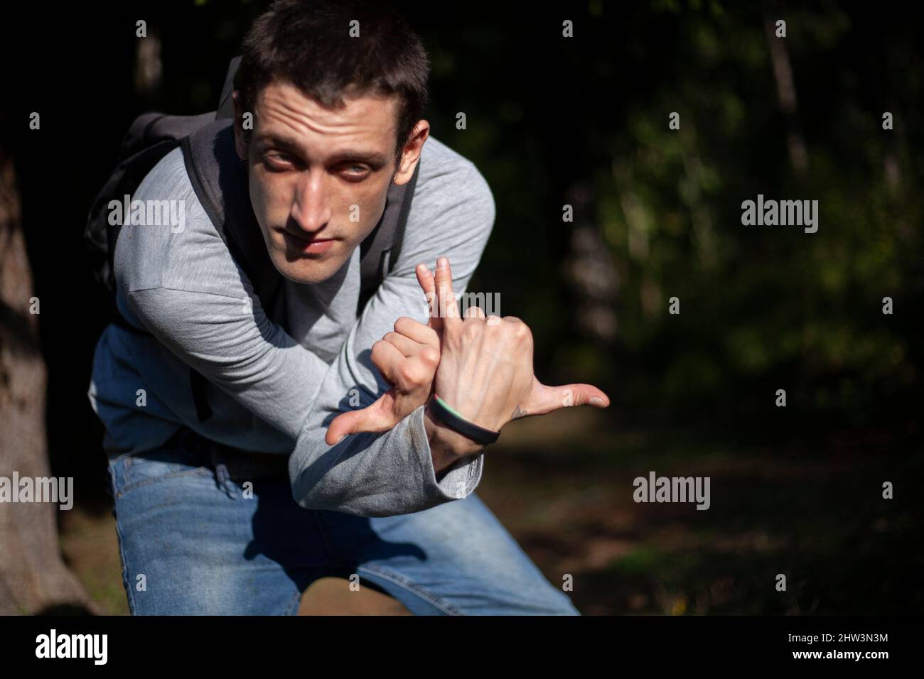 A young man shows gestures with his hands. The guy shows movements with ...