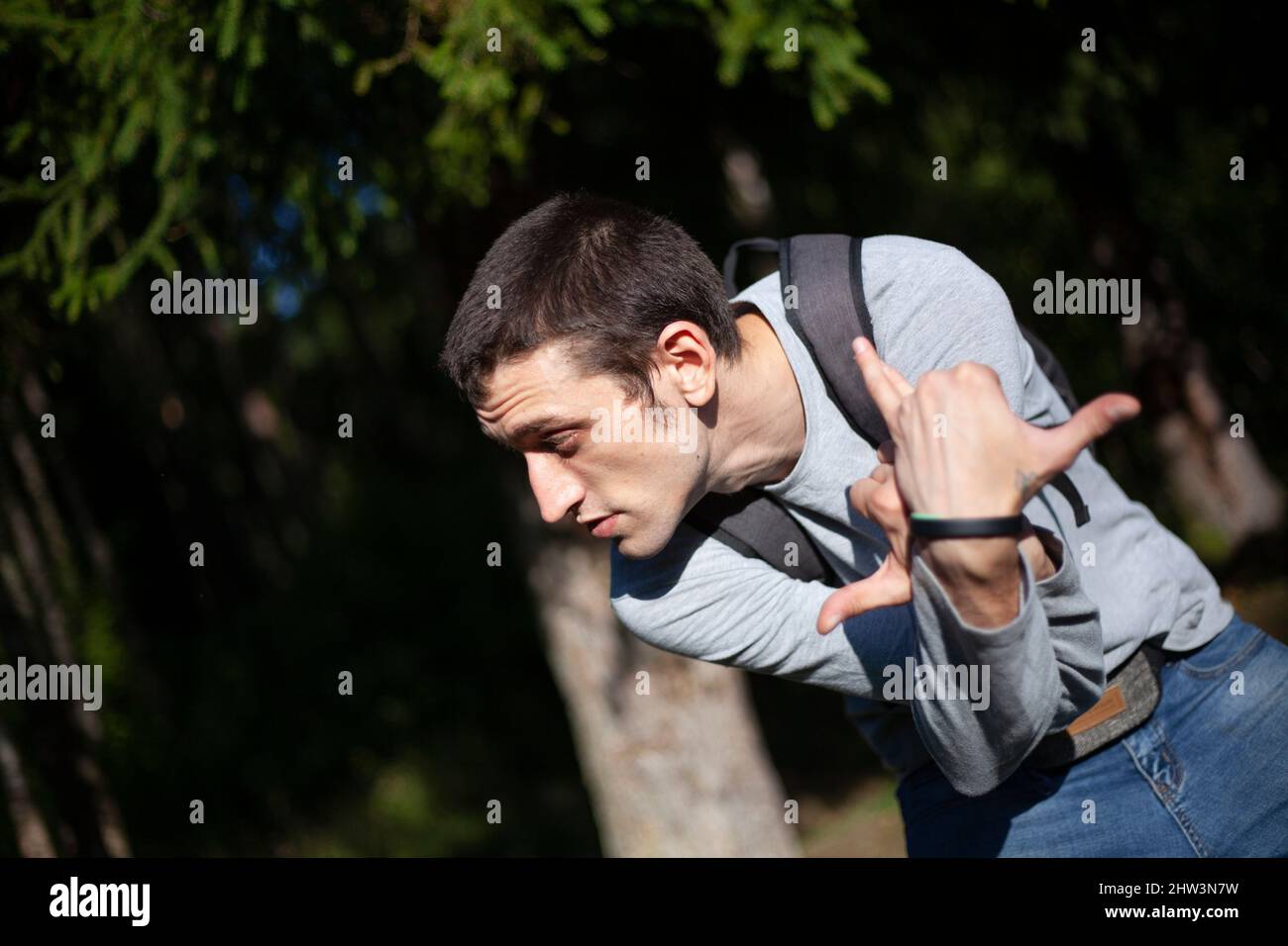 A young man shows gestures with his hands. The guy shows movements with ...