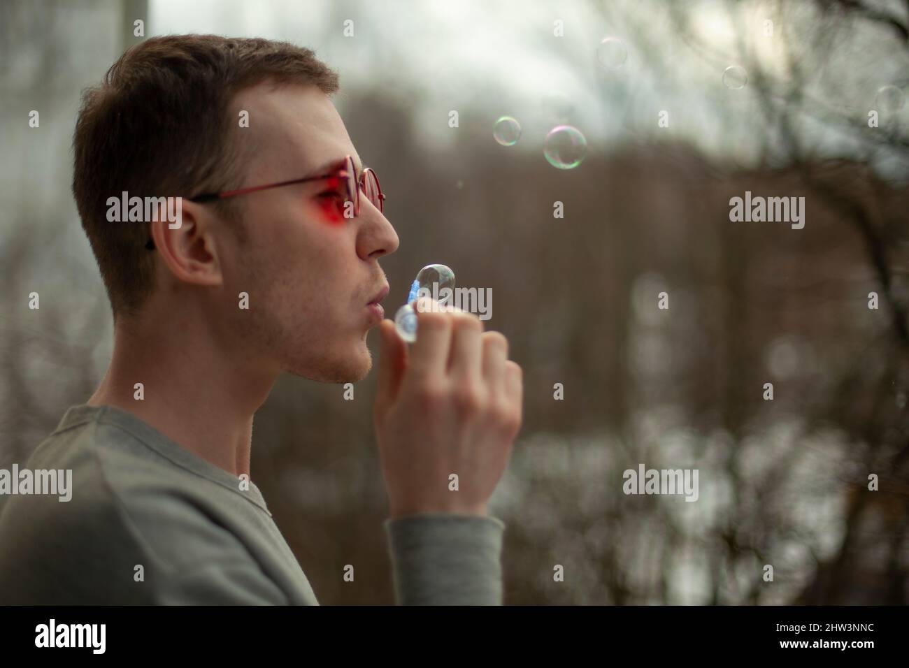 The man lets out soap bubbles. The guy rejoices every day. A young man ...