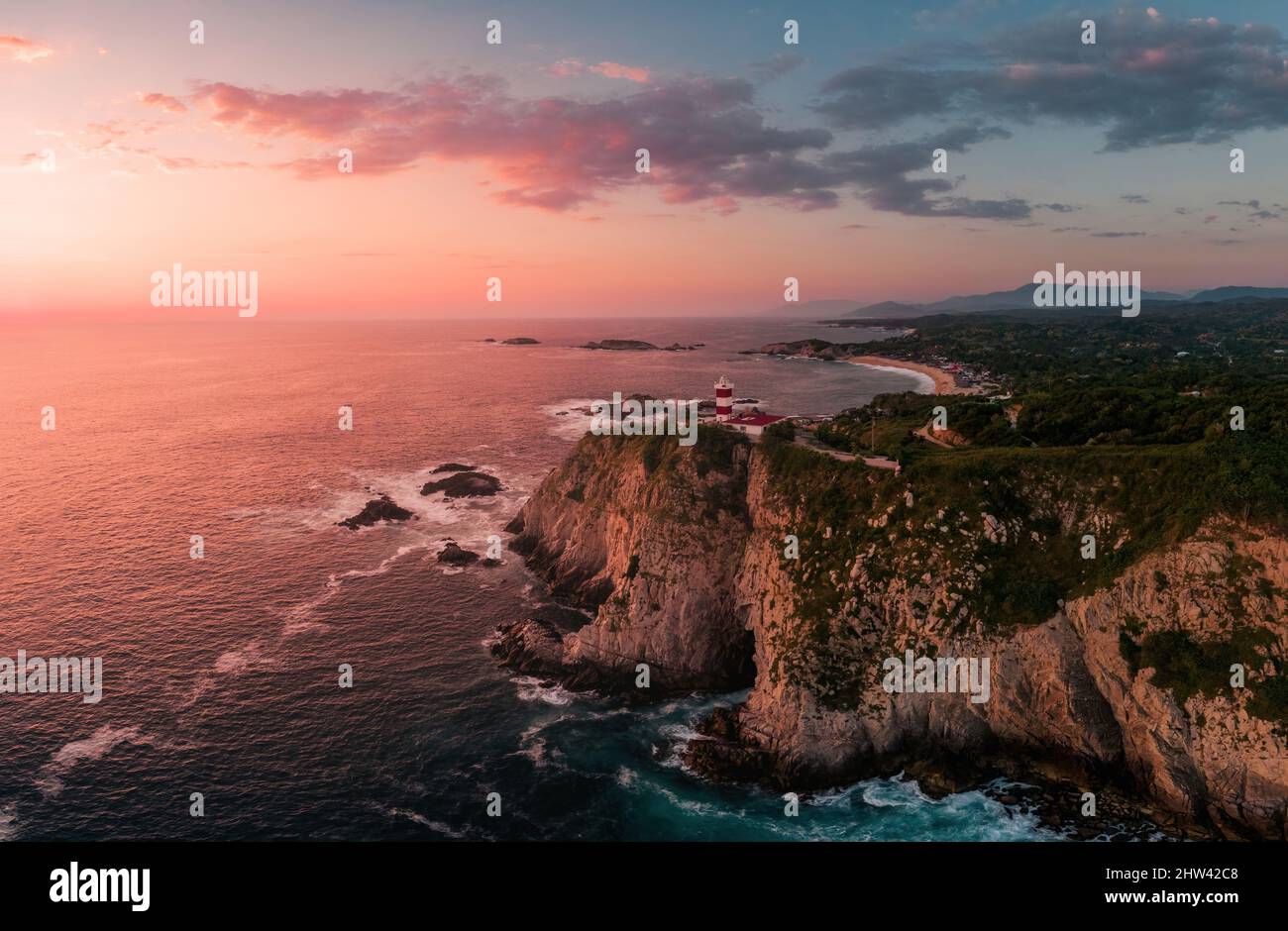Sunset over a lighthouse at the Maruata beach, Michoacan, Mexico Stock ...