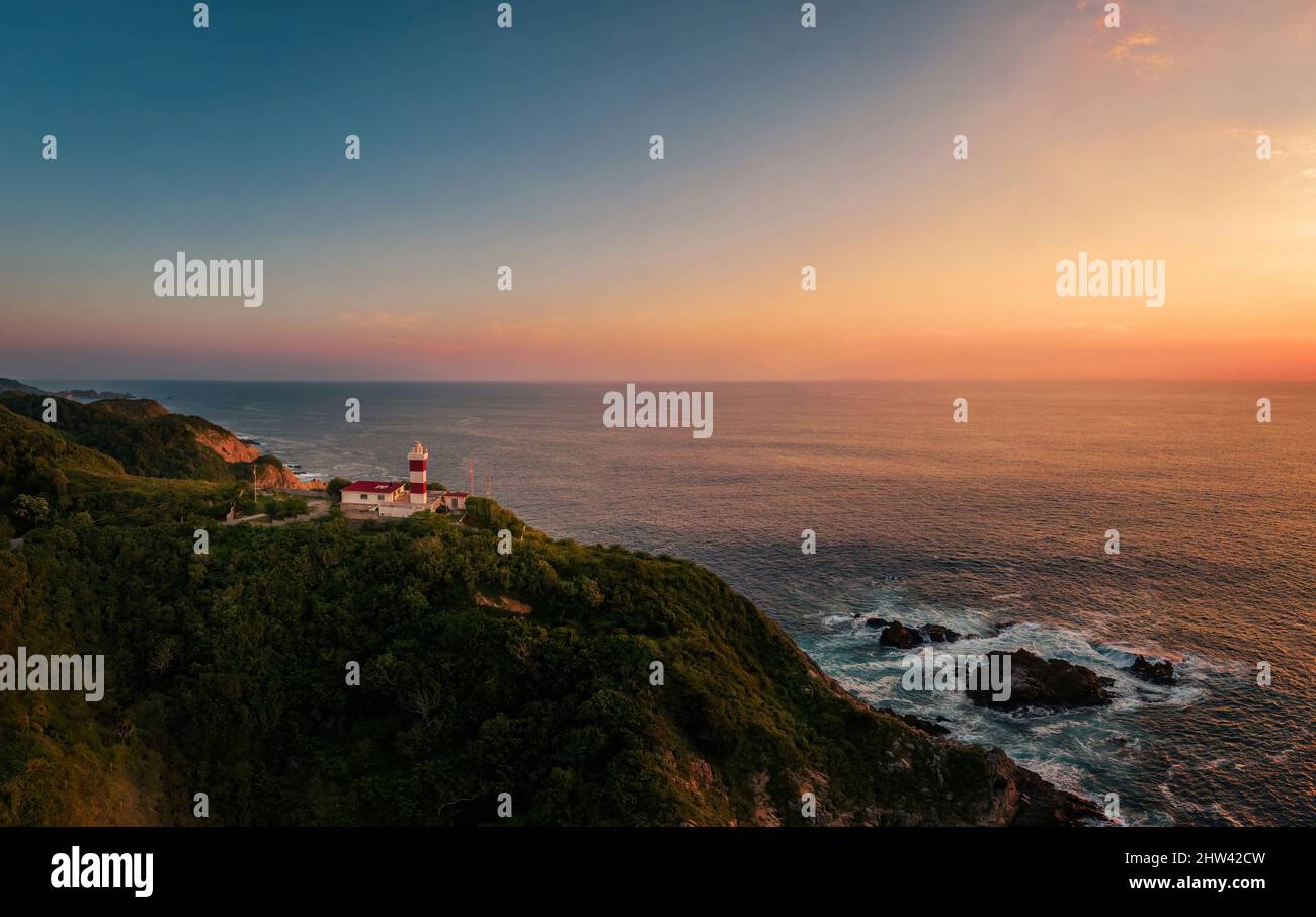 Sunset over a lighthouse at the Maruata beach, Michoacan, Mexico Stock ...