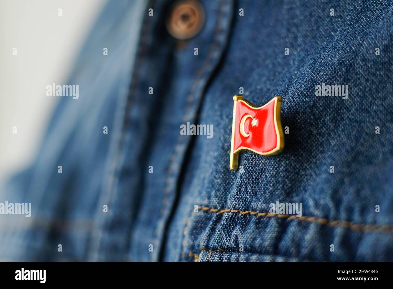 Turkish flag icon is pinned on blue jeans jacket. Turkey patriotism ...