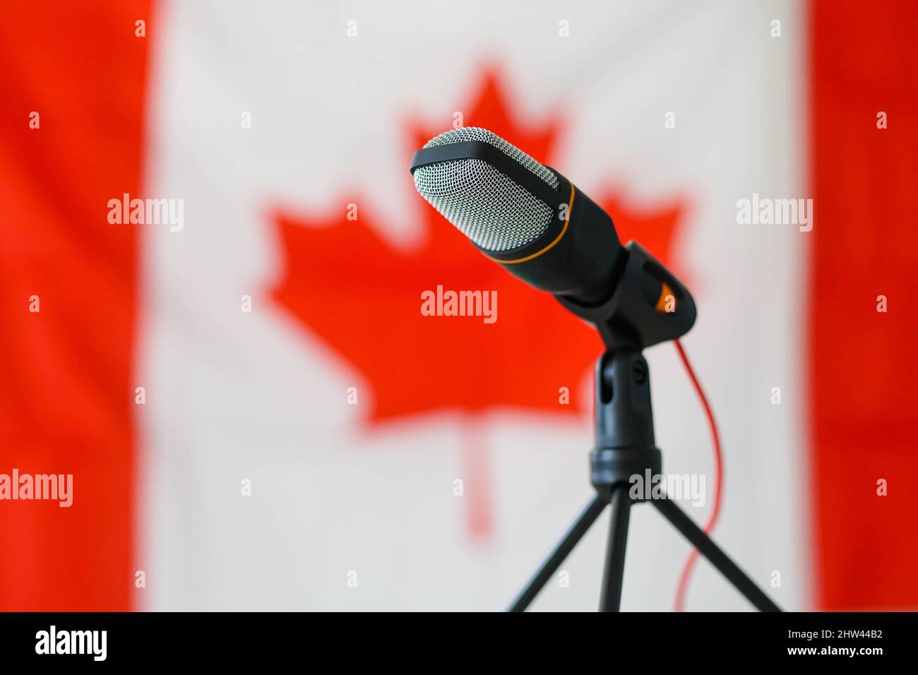 Microphone in front of the Canadian flag. Close up Stock Photo - Alamy