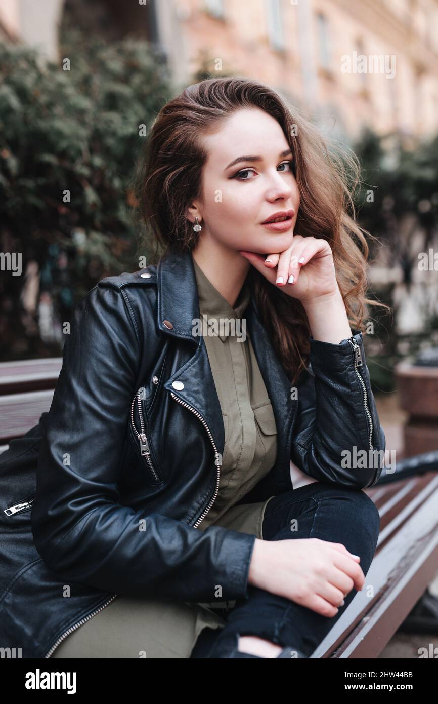 Girl in leather jacket sitting hi-res stock photography and images - Alamy