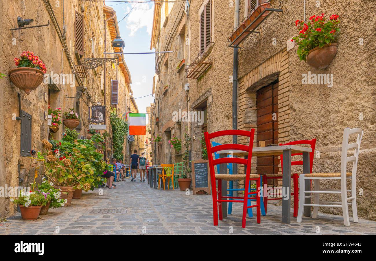 Cozy outdoor cafe with colorful chairs and tables in the old town of Onano, Italy Stock Photo ...