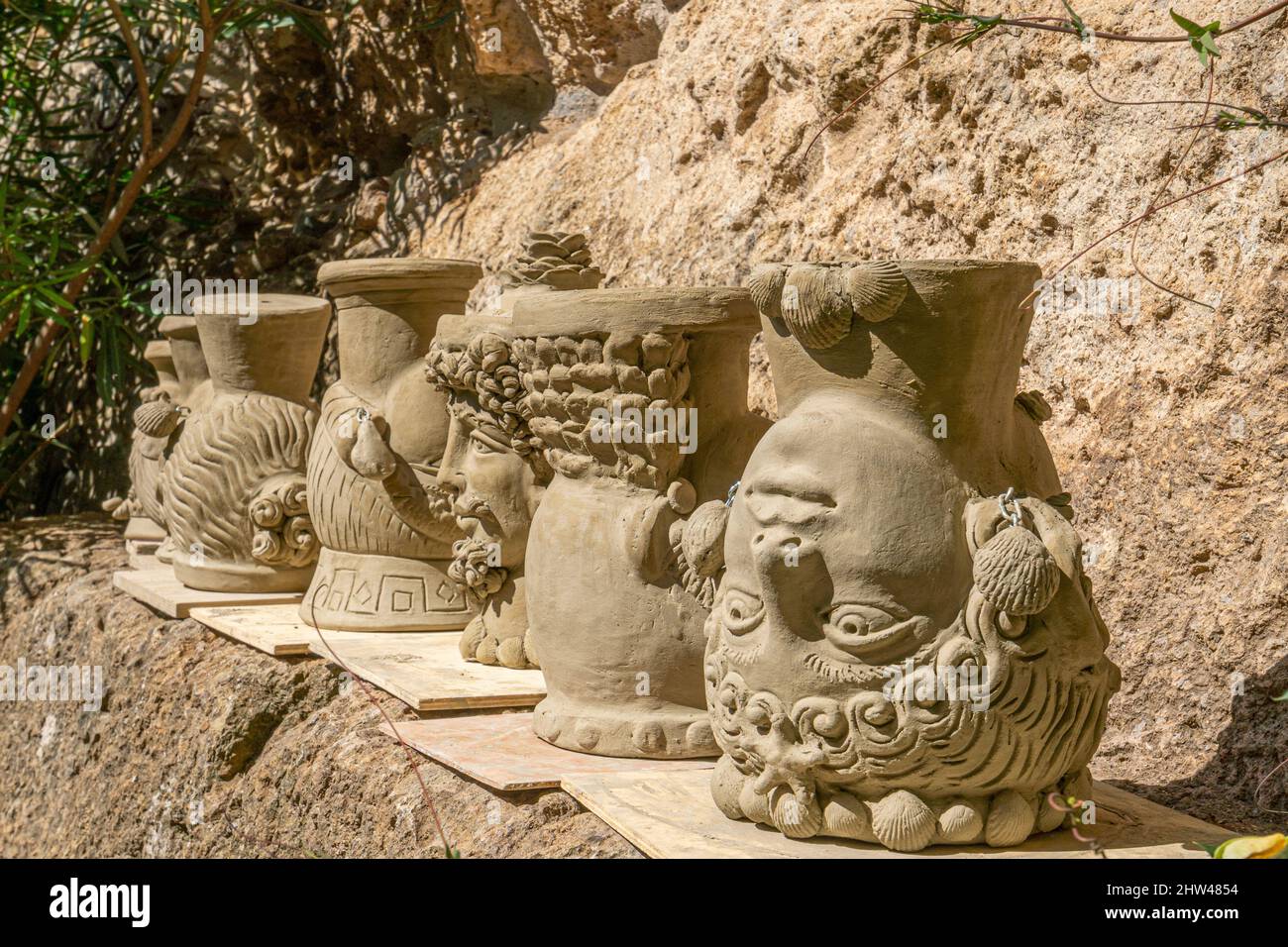 Row of old sculptures exhibited outdoors, cultural heritage of Onano ...
