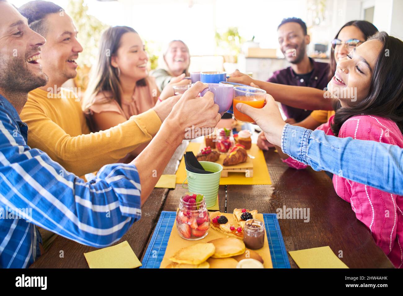 Multicultural People having breakfast drinking coffee and cheers. Happy ...