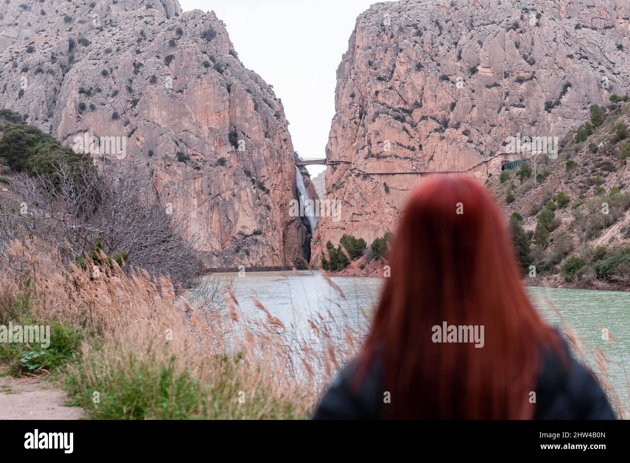 woman observes mini waterfall between two mountains Stock Photo - Alamy