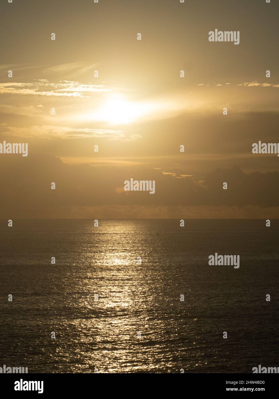 Sunrise on the Pacific Ocean, Golden sun shining through the clouds in ...