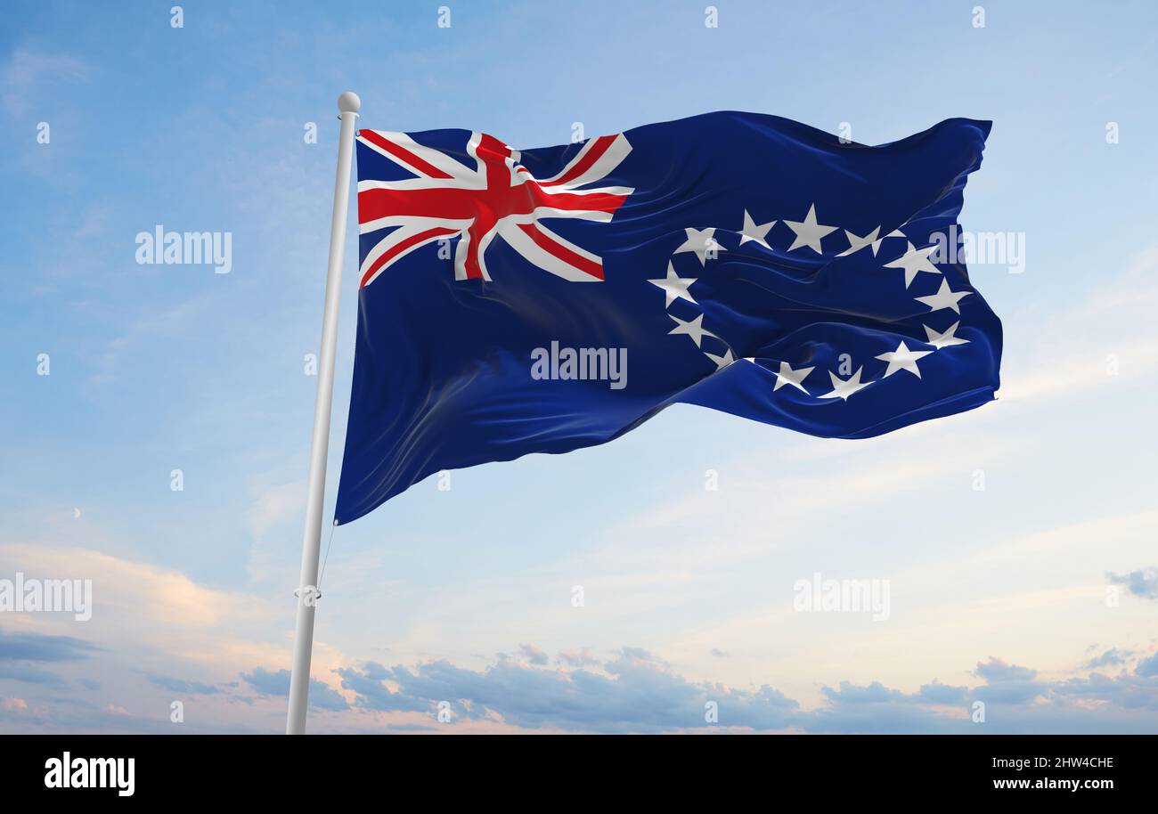 official flag of Cook Islands at cloudy sky background on sunset ...