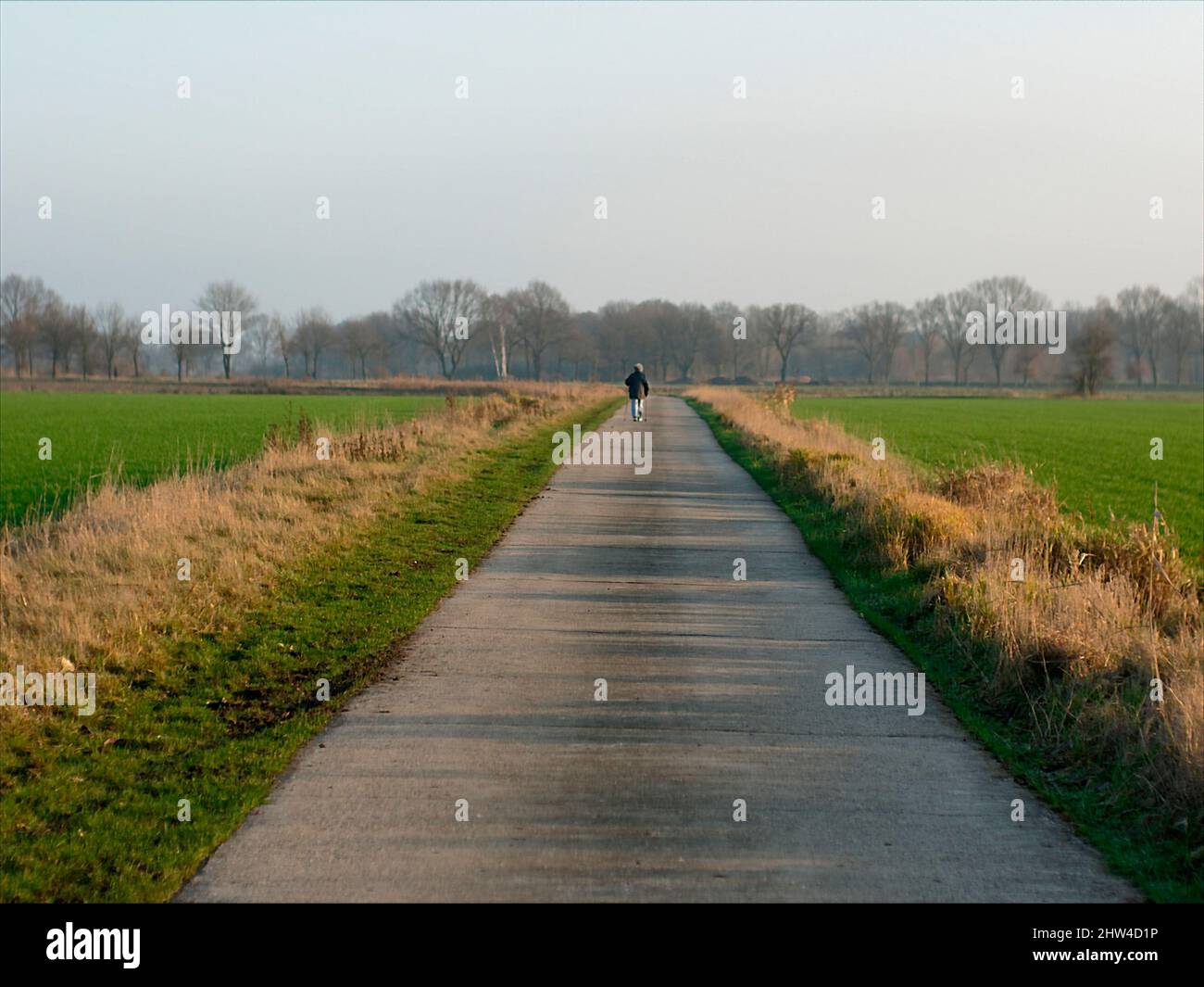Woman walking on country lane hi-res stock photography and images - Alamy