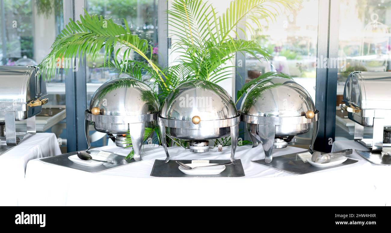 Buffet Table with Row of Food Service Steam Pans in the restaurant ...