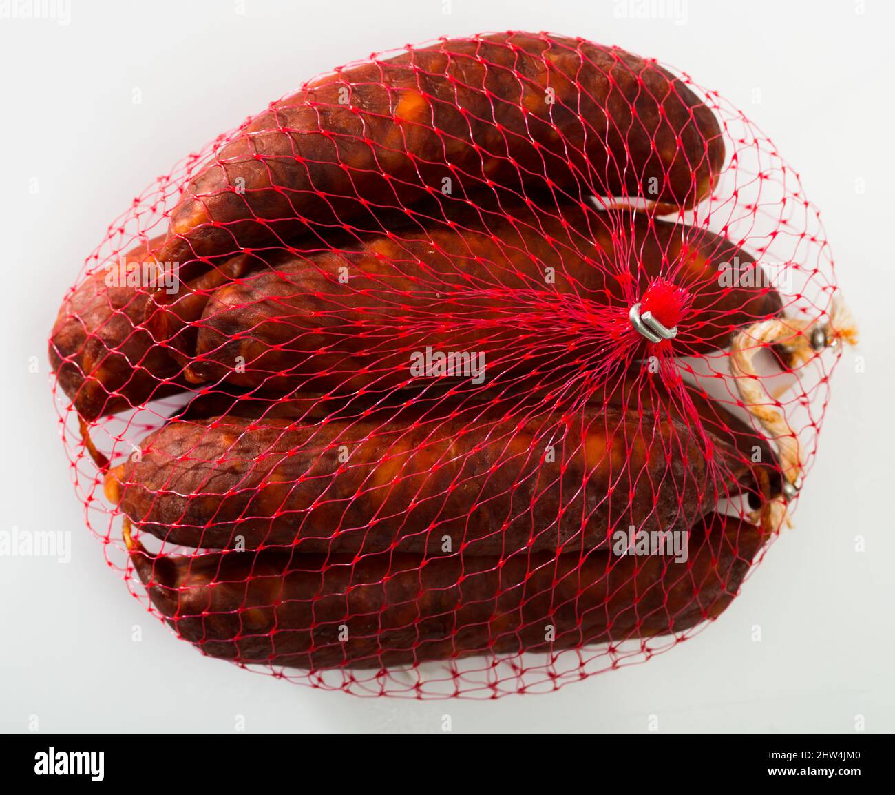 Sausages chorizo in packaging net Stock Photo - Alamy
