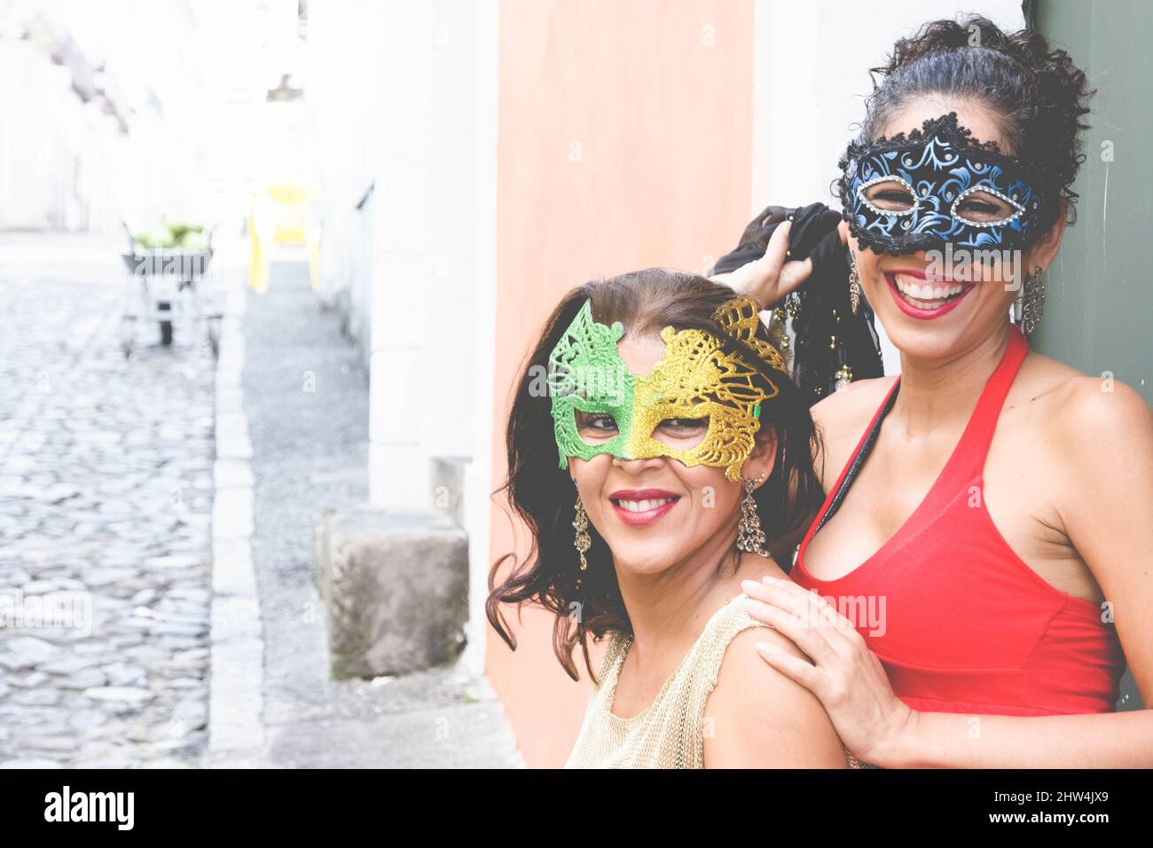 Portrait of two women wearing Venice Carnival mask. Salvador, Bahia ...