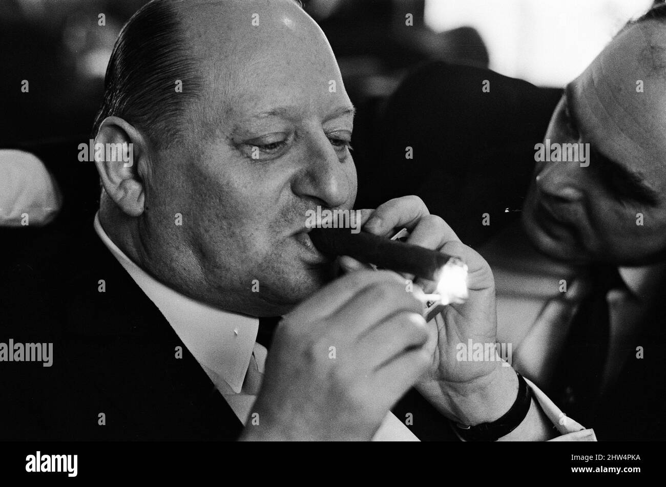 Media Mogul Lord Lew Grade lighting his cigar with a match. 24th ...