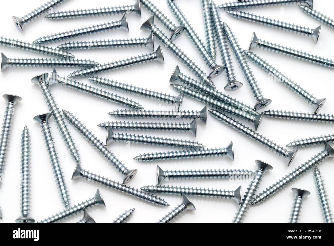 silver metallic tapping screws on white background Stock Photo - Alamy