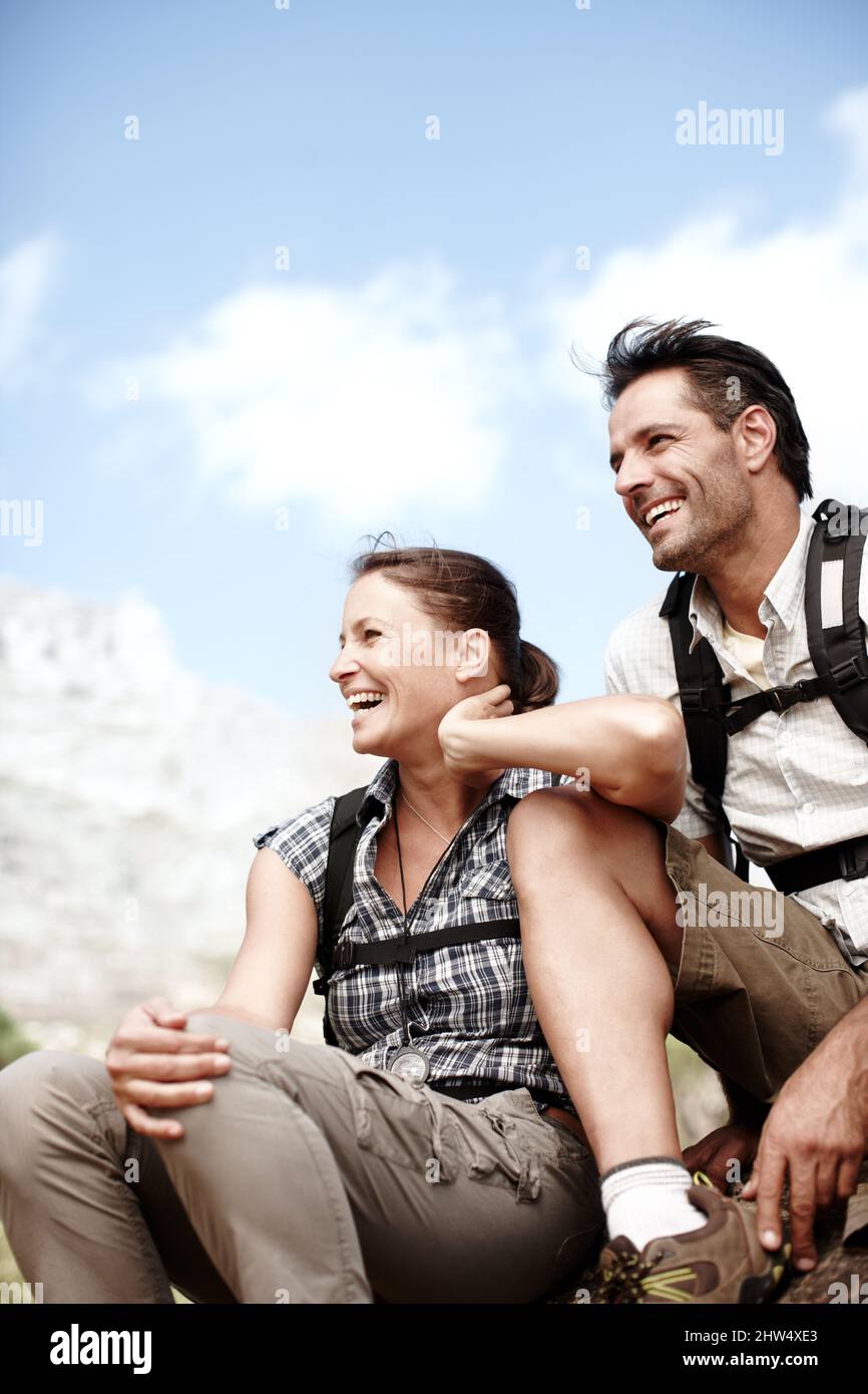 Wow, what a great view. Two hikers laughing and smiling while enjoying ...