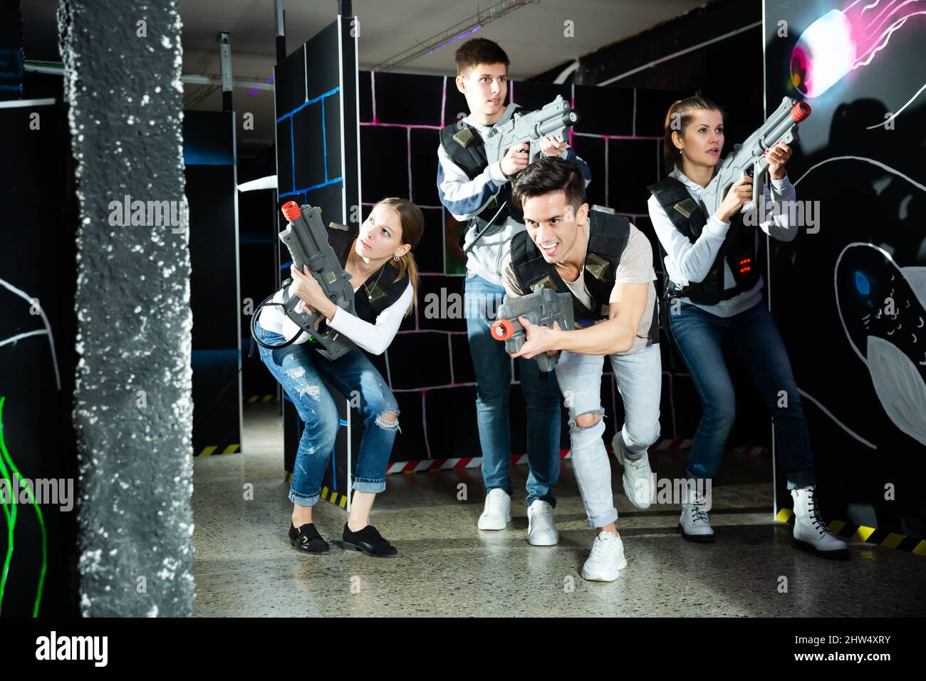 Guy with friends playing laser tag Stock Photo - Alamy