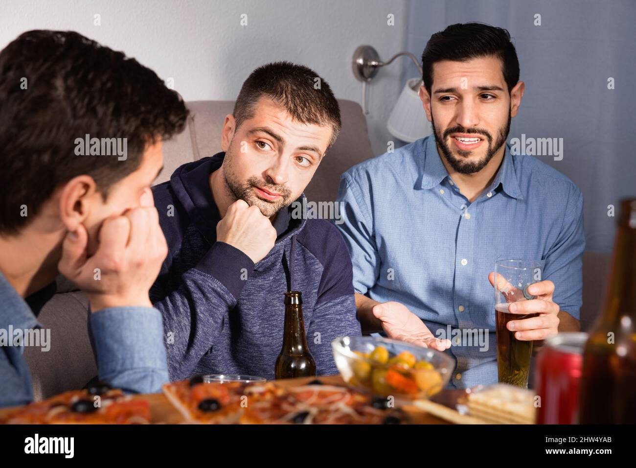 Male friends talking and drinking beer hi-res stock photography and ...