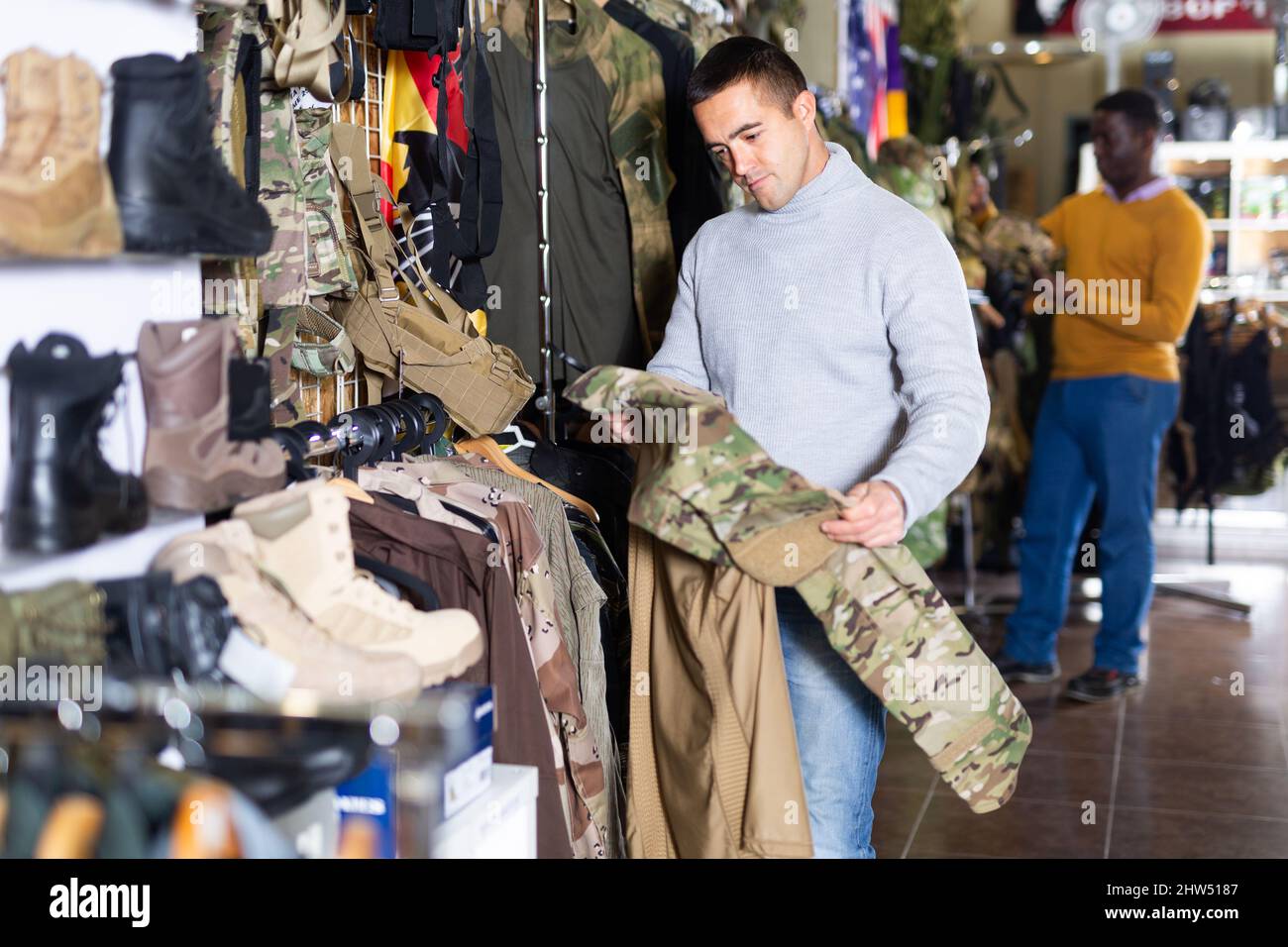 Caucasian man in military goods store Stock Photo - Alamy