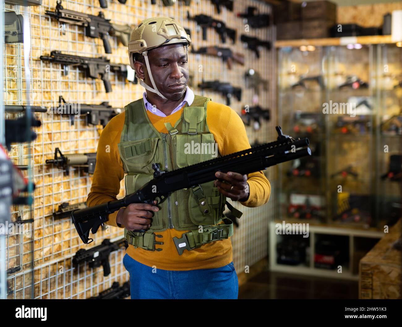 African american man in army uniform with weapon in military shop Stock ...