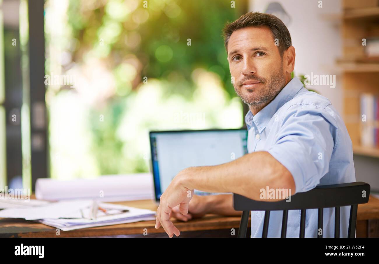 Building my company from the ground, up. Shot of a young man working ...