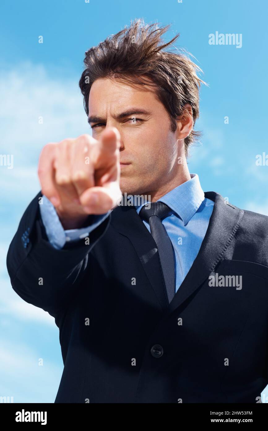 A stern business man points his finger at you. Portrait of a stern ...
