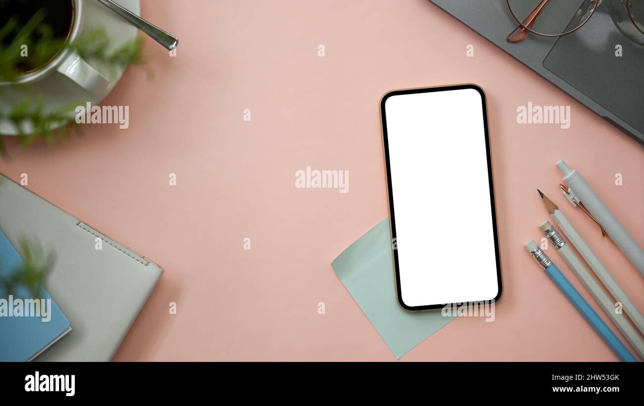 Pink workspace background with smartphone blank screen mockup ...