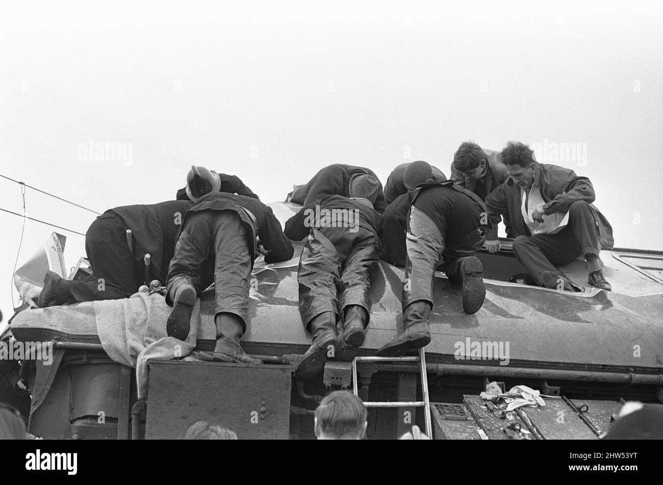 Fire fighters work to rescue one of the victims of the Hixon rail ...