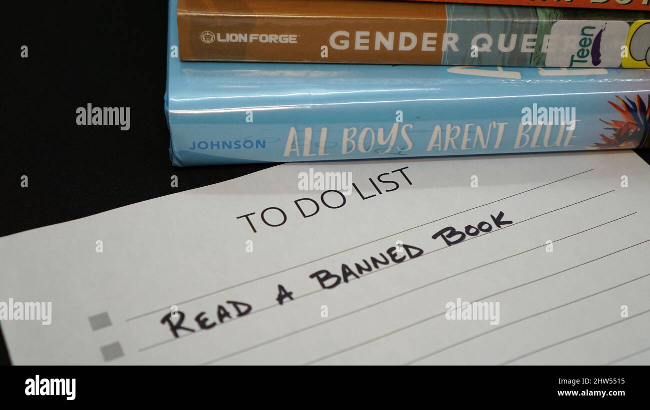 To do list reminder to read a banned book, along with a pile of books ...