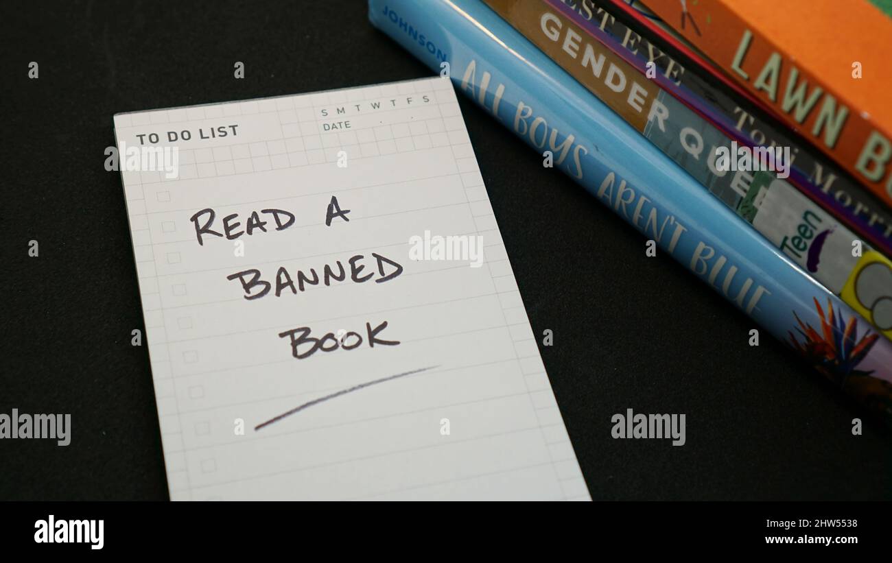 To do list reminder to read a banned book, along with a pile of books ...