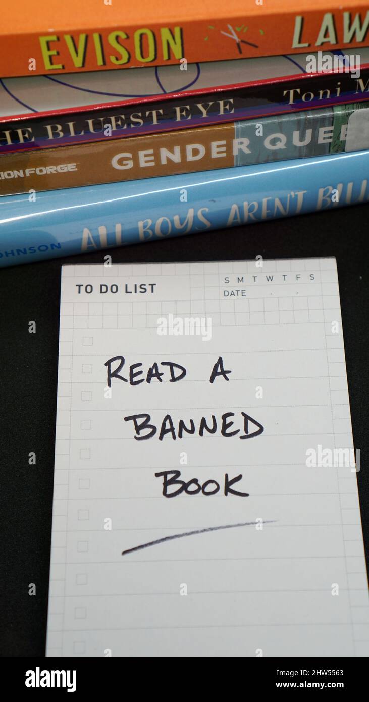 To do list reminder to read a banned book, along with a pile of books ...